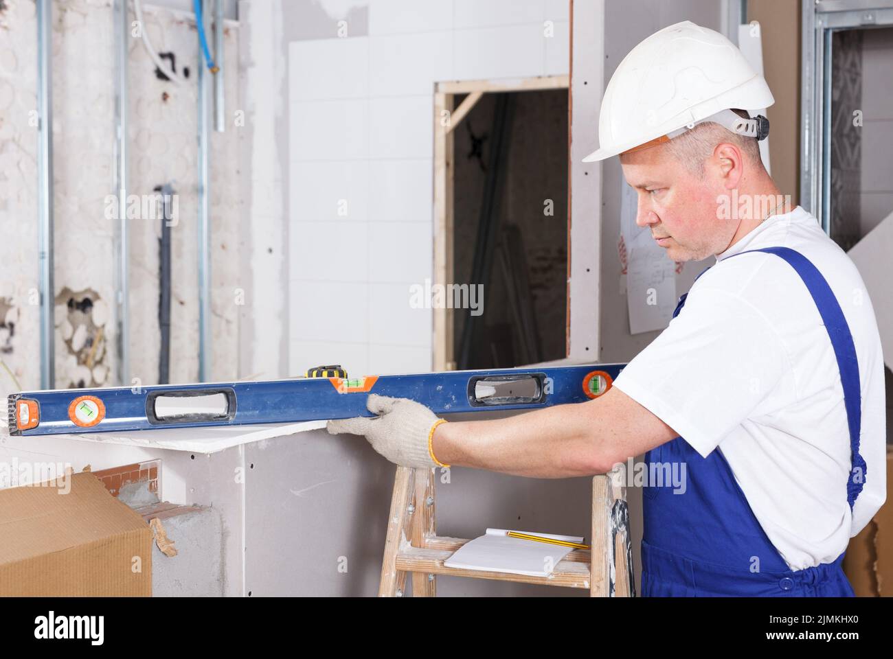 Builder measuring drywall construction Stock Photo - Alamy