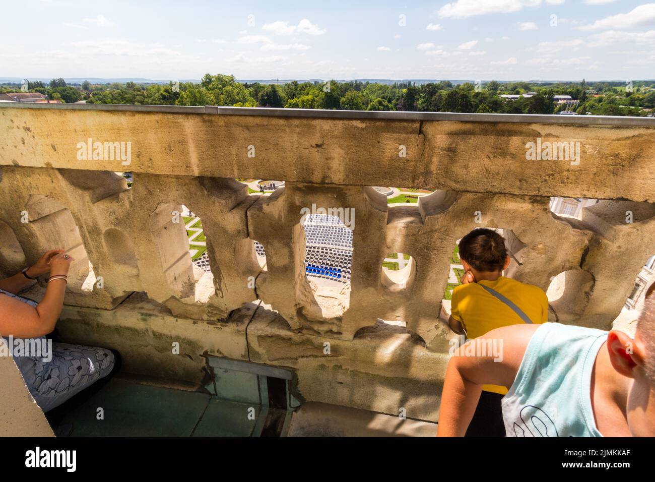 People peeping through stone balustrade of tower of Helikon Palace ...