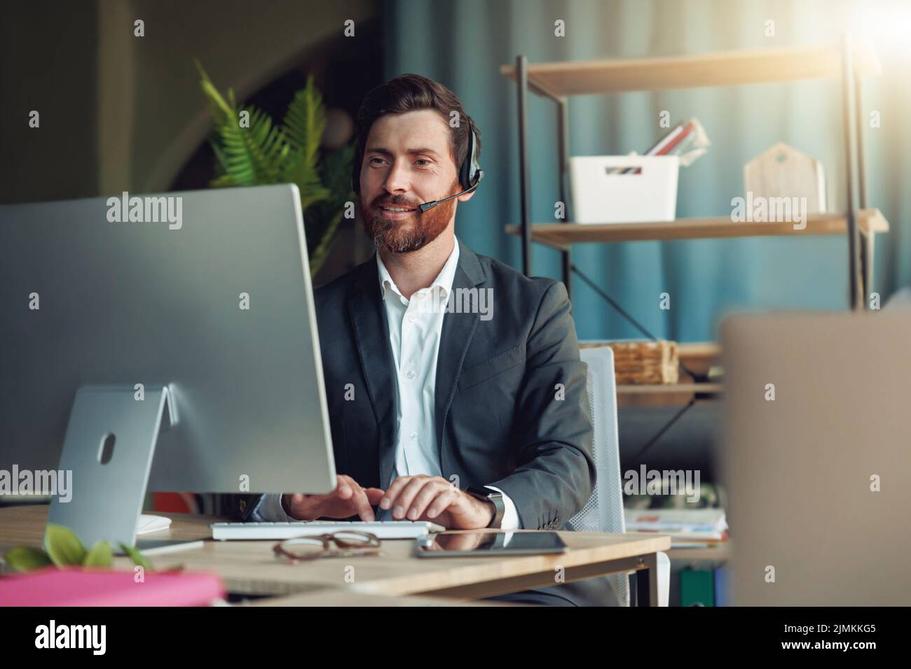 Male office worker sitting on his workplace while working computer ...