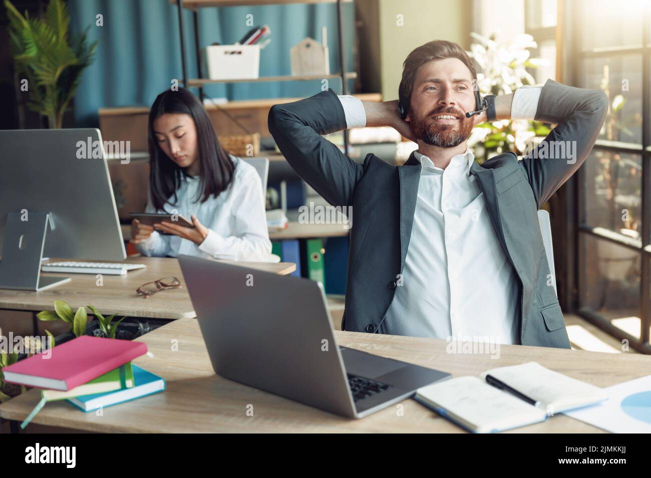 Man office worker have a rest on his workplace on background of ...