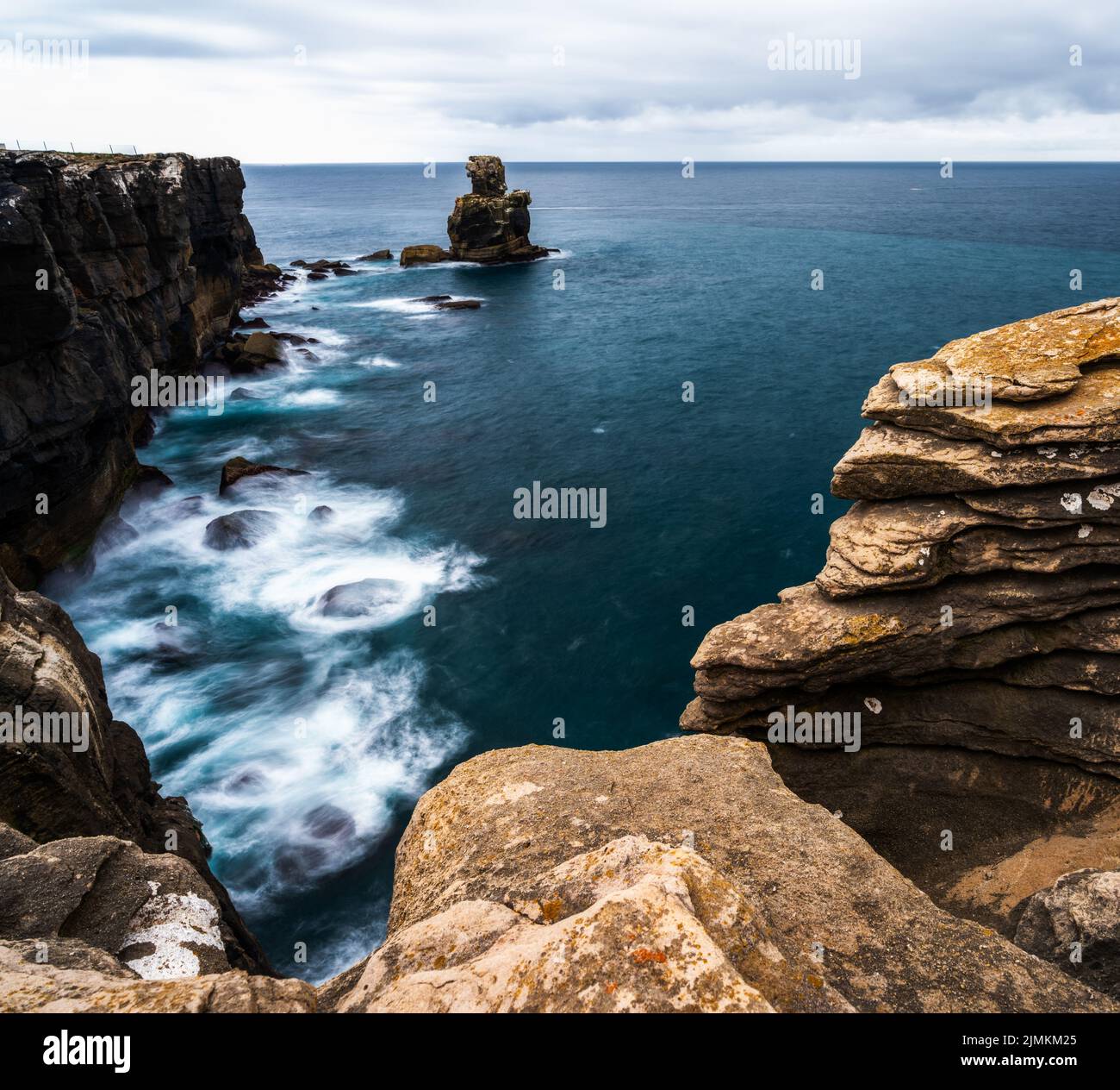 View of wild shoreline and cliffs drop into a deep blue Atlantic Ocean ...