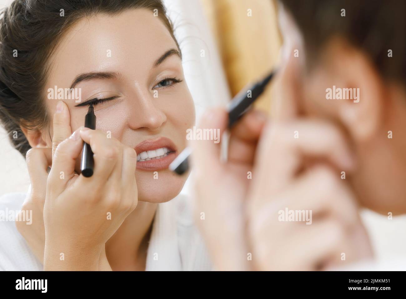 Woman is disappointed with her skill of applying makeup Stock Photo - Alamy