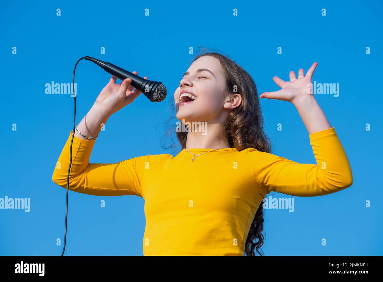 happy teen child singing karaoke in microphone Stock Photo - Alamy