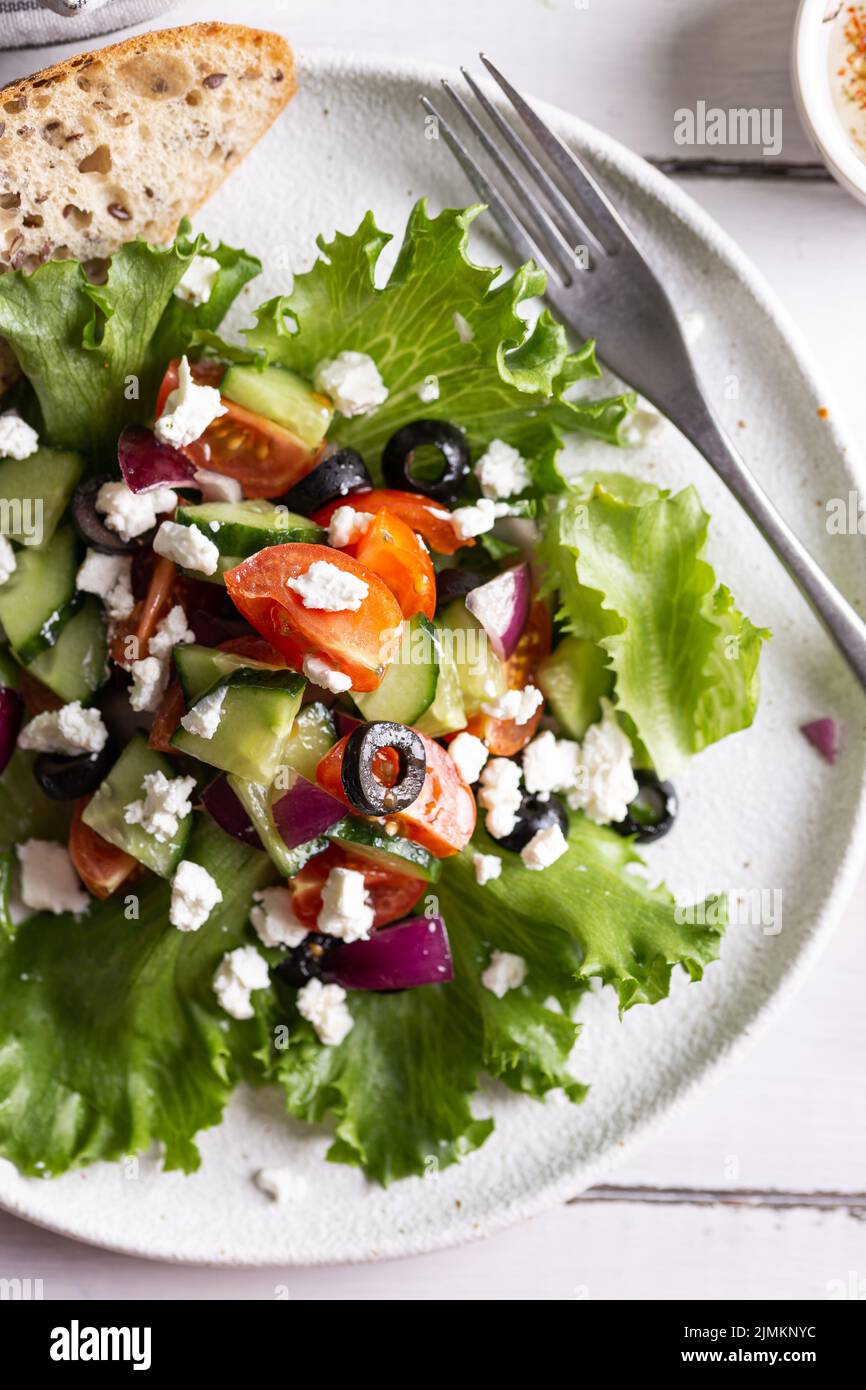 Plate with greek salad for dinner Stock Photo - Alamy