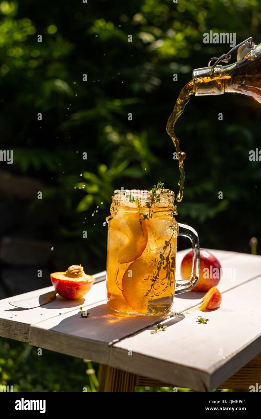 Pouring iced tea into a glass Stock Photo - Alamy