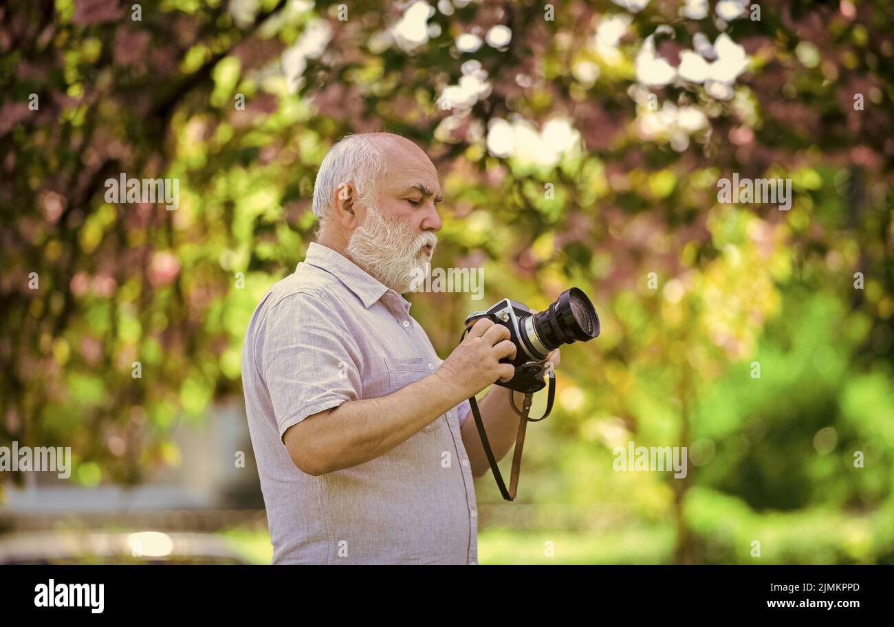 Cameraman outdoors. Photographer shooting nature. Creating memories for ...