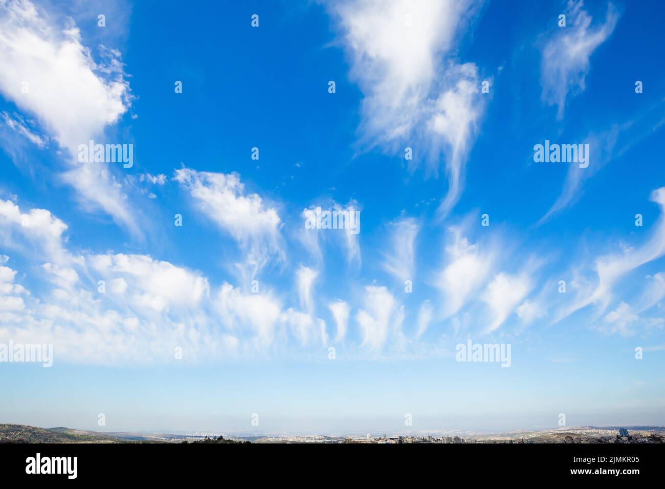 Flying cirrus clouds over blooming land Stock Photo - Alamy
