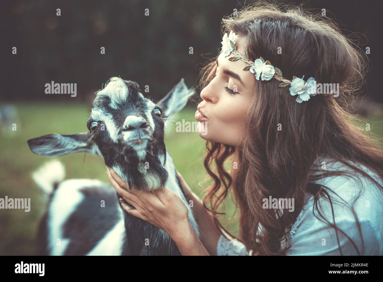 Beautiful woman with a funny friendly goat in the village Stock Photo ...
