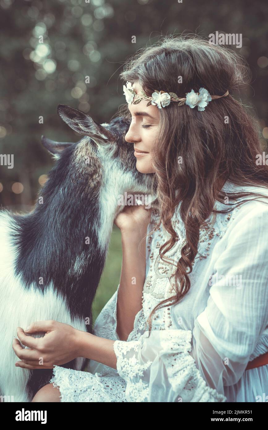 Beautiful woman with a funny friendly goat in the village Stock Photo ...