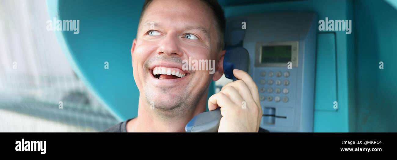 Happy man speaks on a public payphone, close-up Stock Photo - Alamy