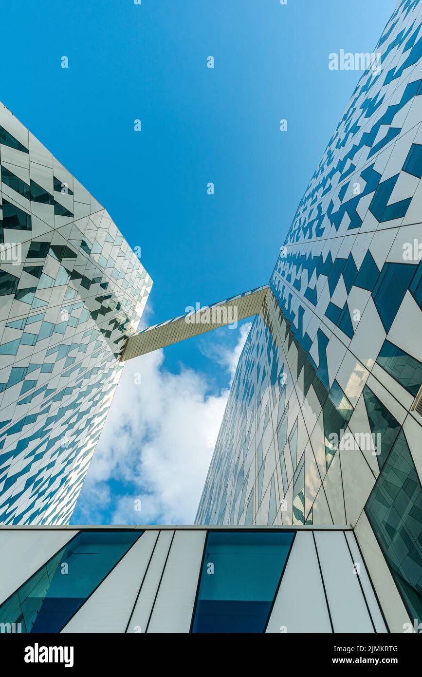 Bottom view of a white glass modern building AC Hotel Bella Sky in city ...