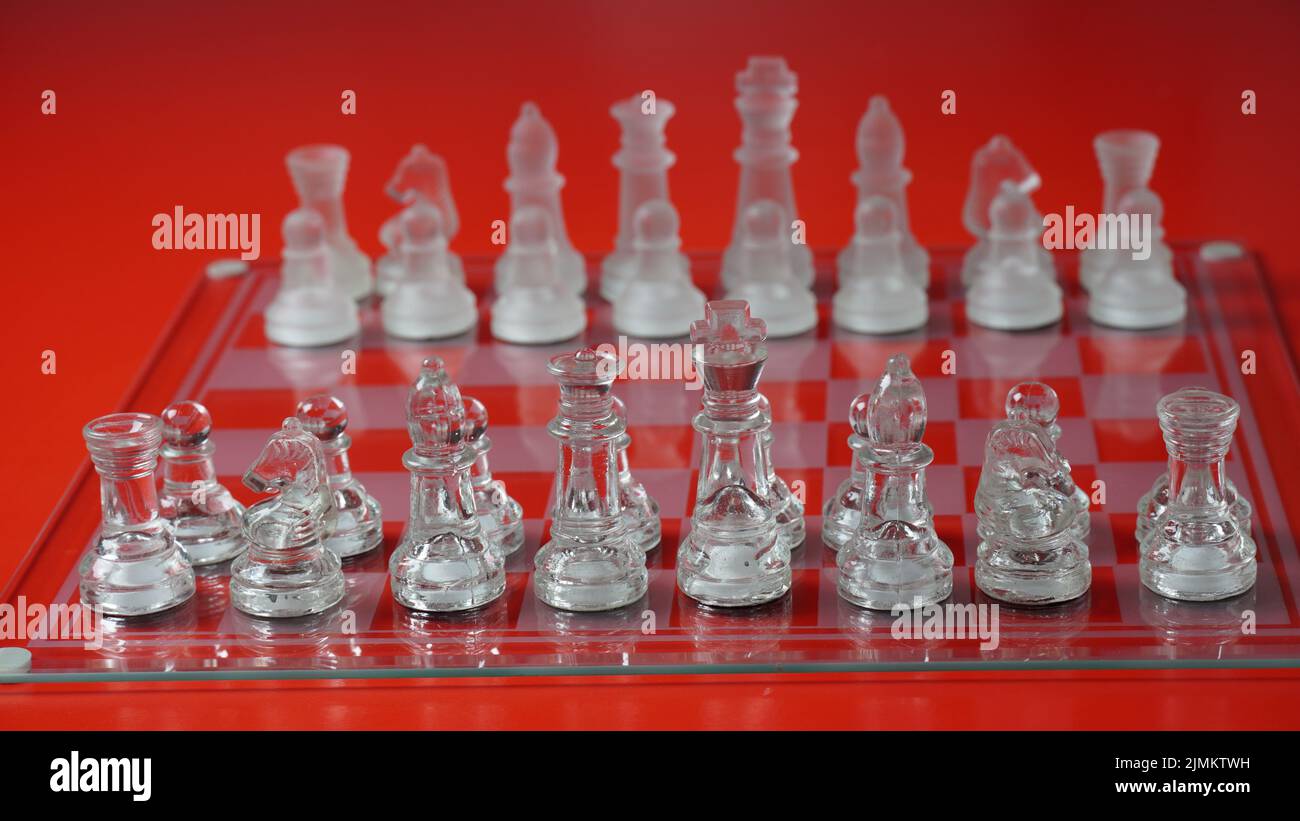 Transparent chess figures, on starting position, on reflective chess ...