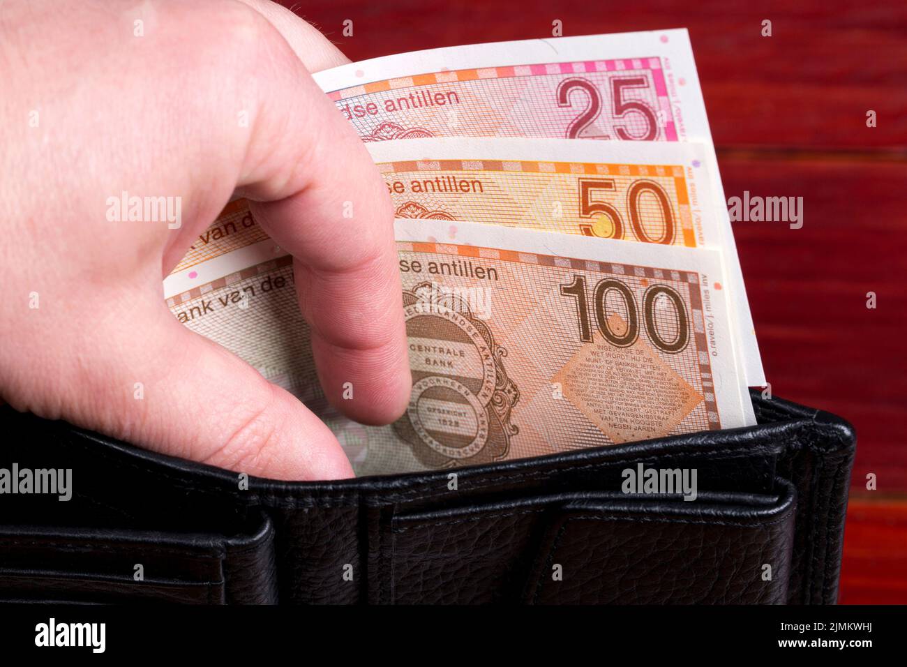 Netherlands Antillean money - guilder in the black wallet Stock Photo ...