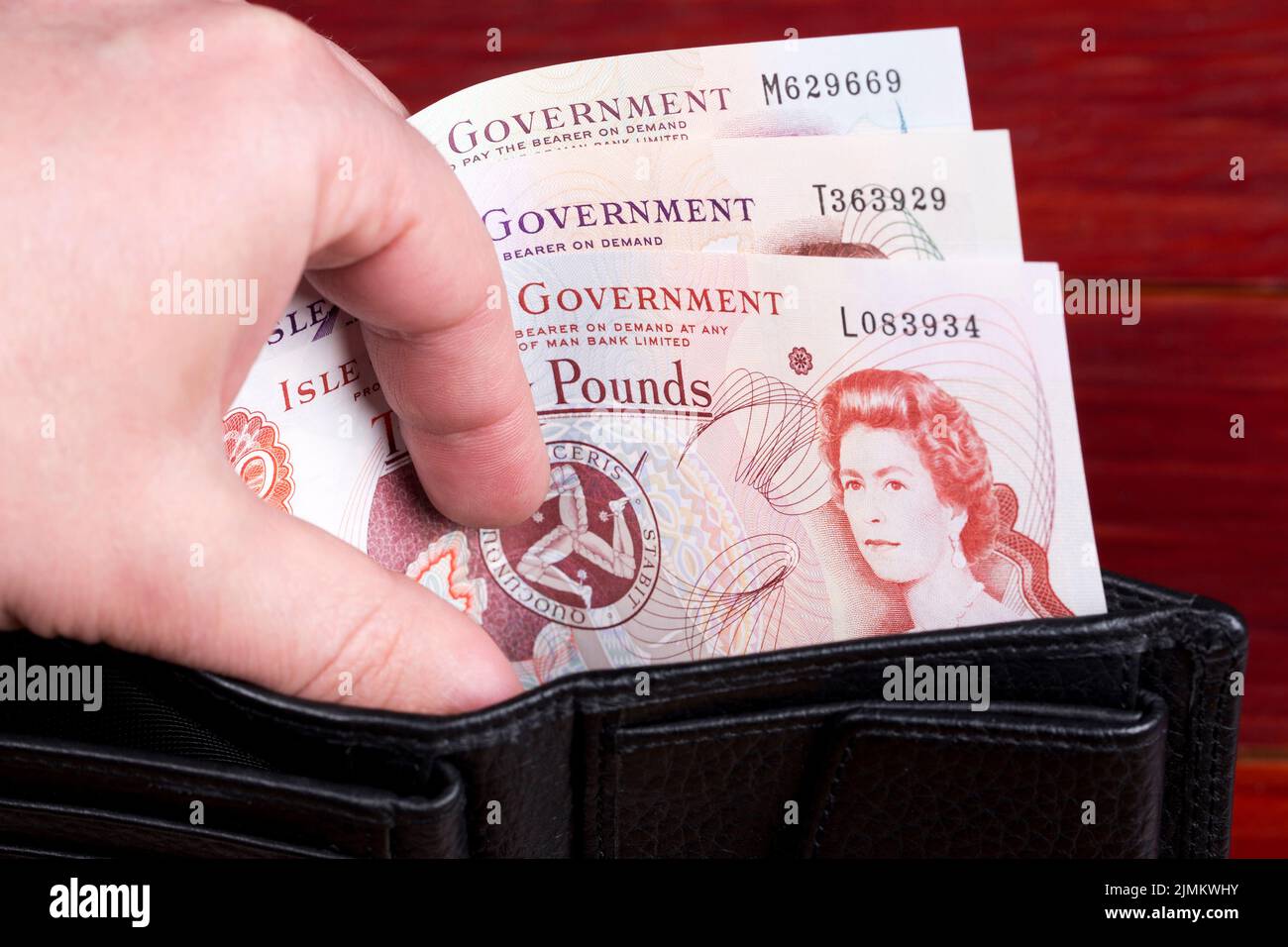 Currency of the Isle of Man - Pounds in the black wallet Stock Photo ...