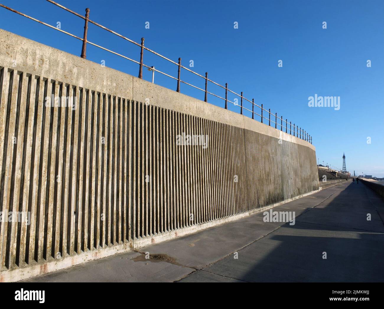 Concrete seawall and railings along the pedestrian promenade in north ...