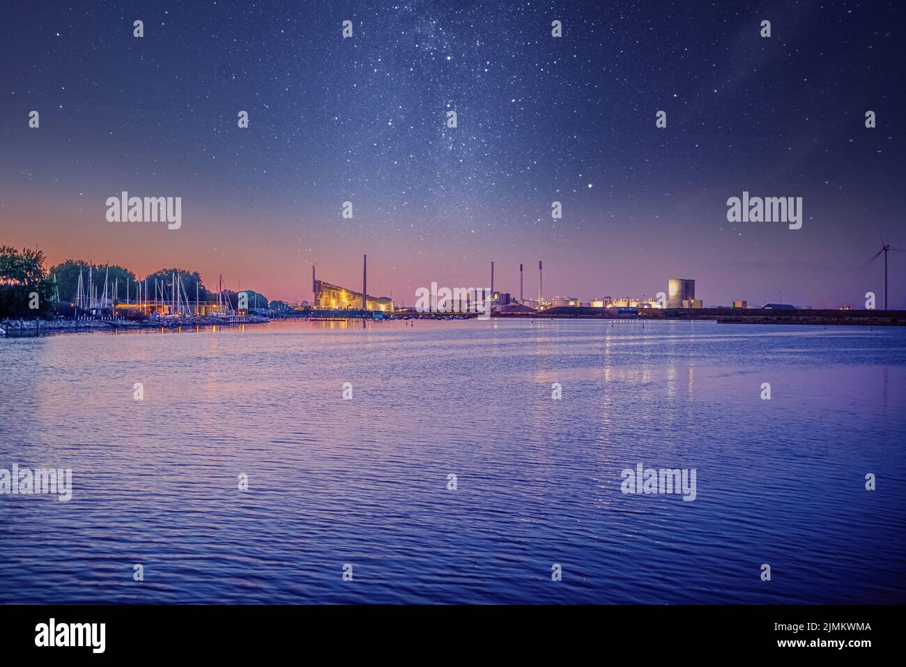 Sea bay with yachts, factory pipes and a processing factory against the ...