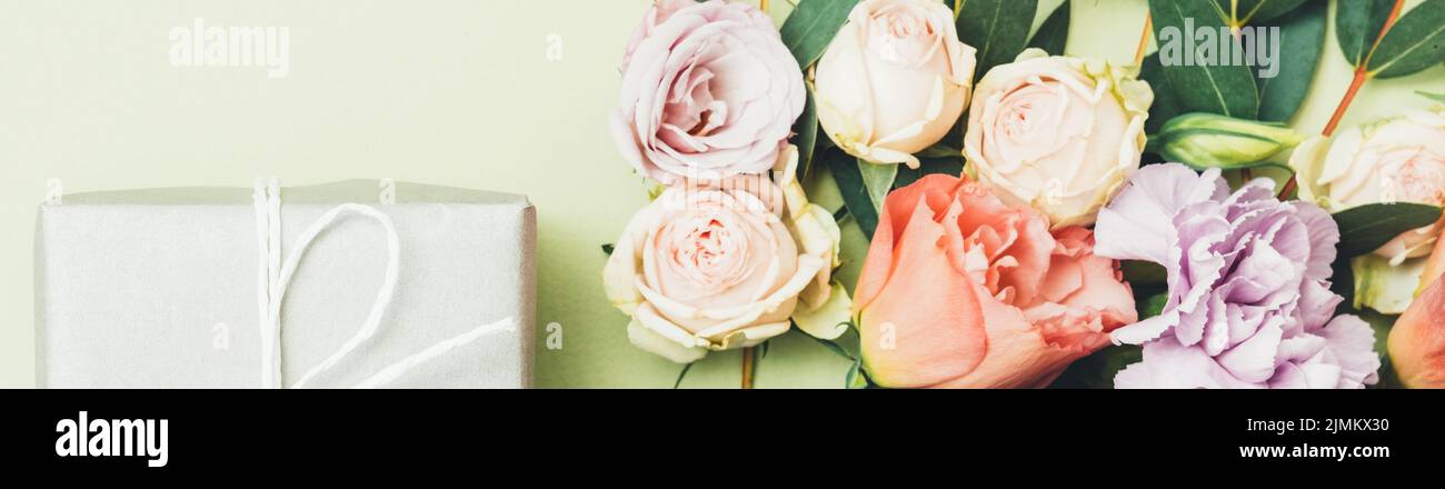 holiday surprise silver gift box multicolor roses Stock Photo - Alamy