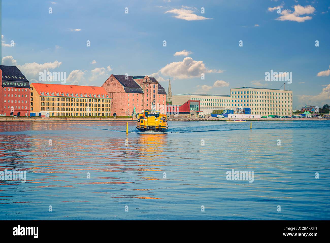Yellow Copenhagen Harbour water Bus floats along the canal near the old ...
