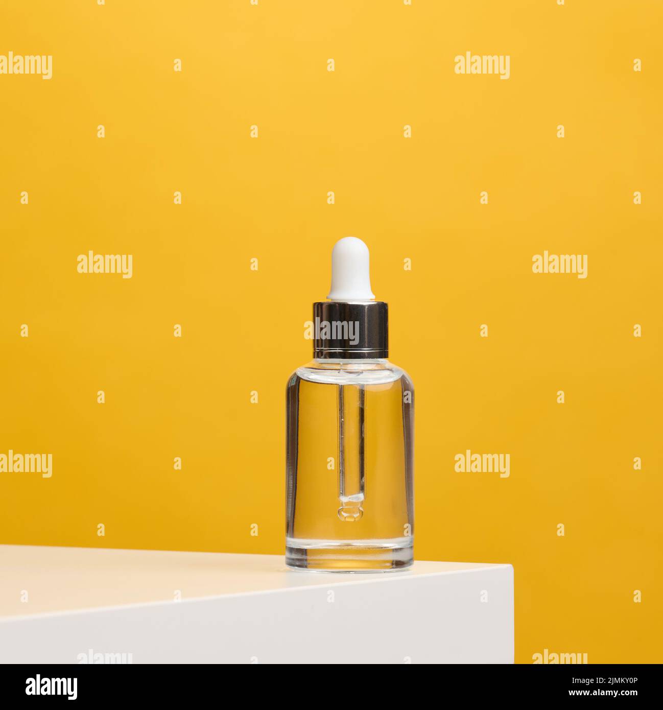 White glass transparent bottle with a pipette for cosmetics, oils ...