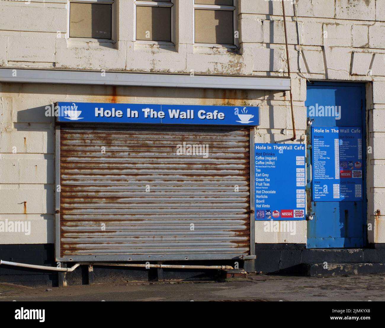 Hole in the wall cafe on the seafront in blackpool with closed shutter ...