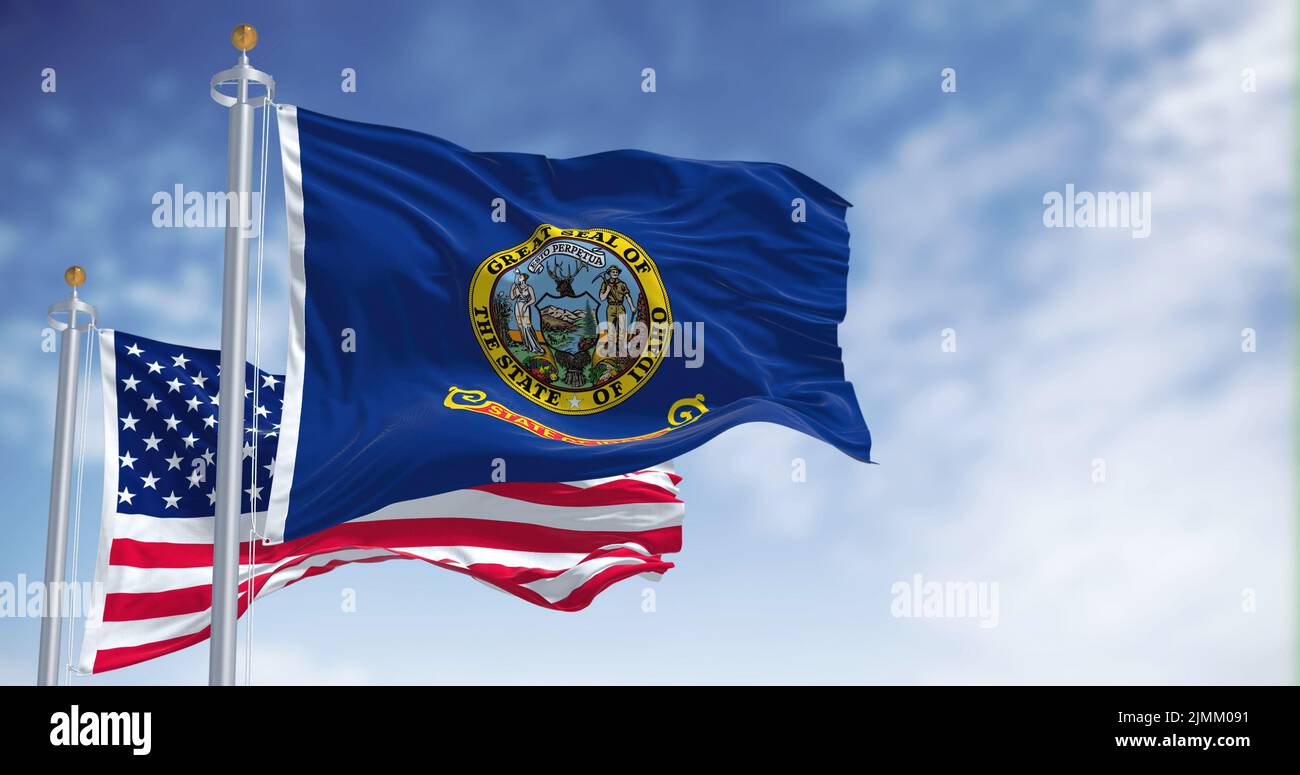 The Idaho state flag waving along with the national flag of the United ...