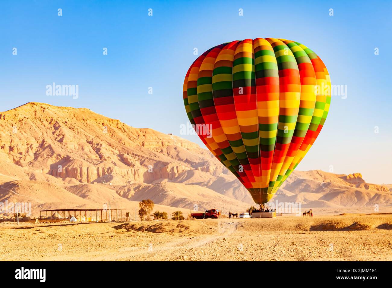 View of colorful hot air balloons with passengers landing on the plane ...