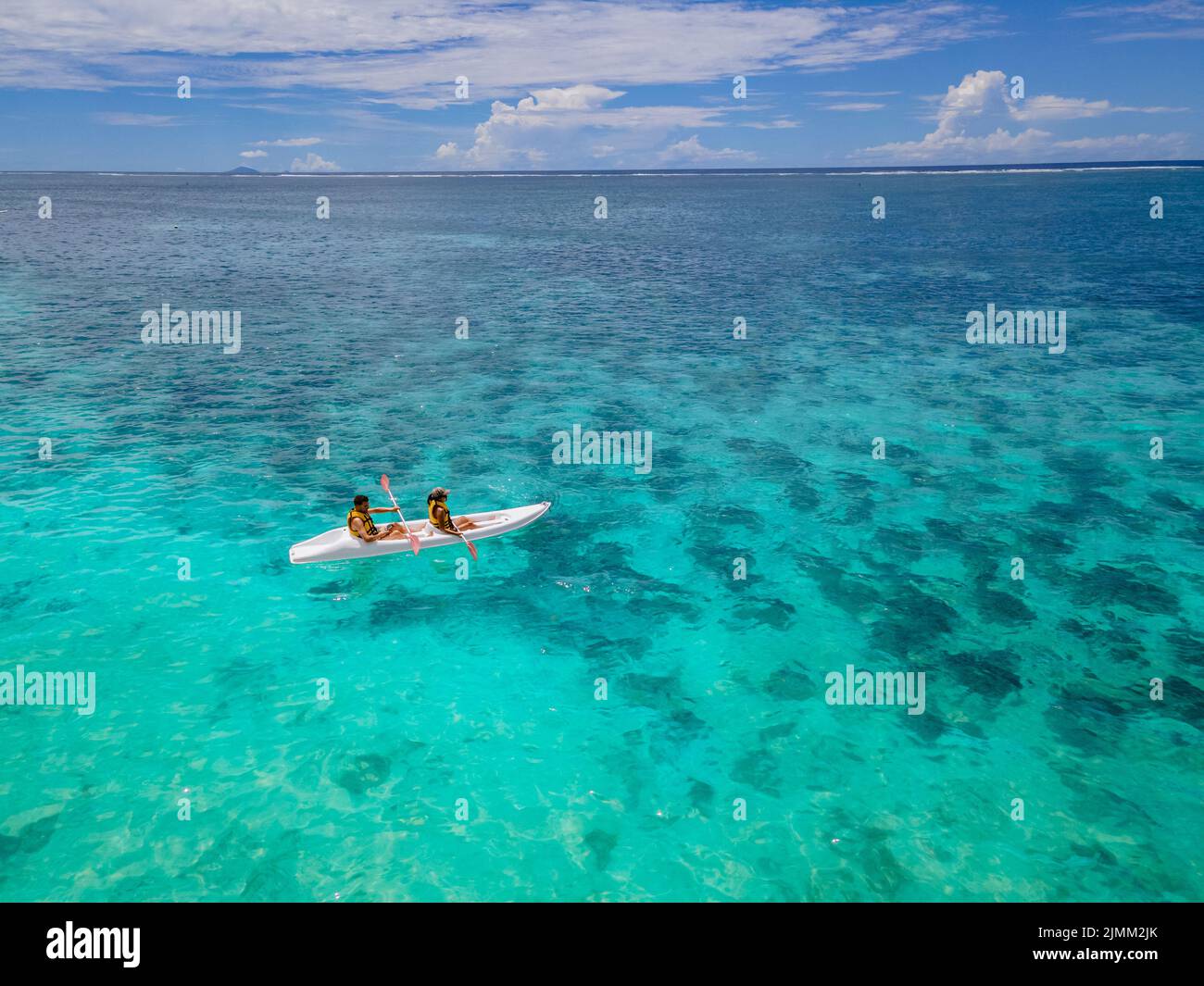 Mauritius vacation, couple man and woman in kayak in a bleu ocean in ...