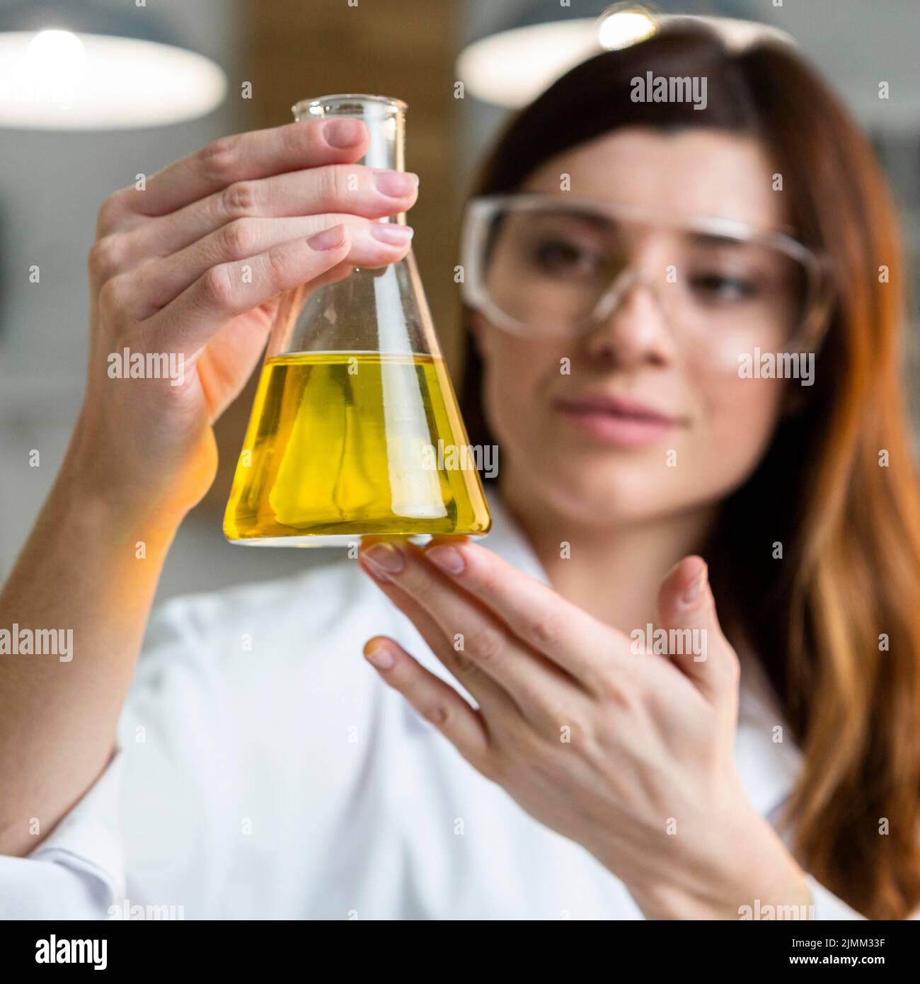 Defocused female scientist holding test tube Stock Photo - Alamy