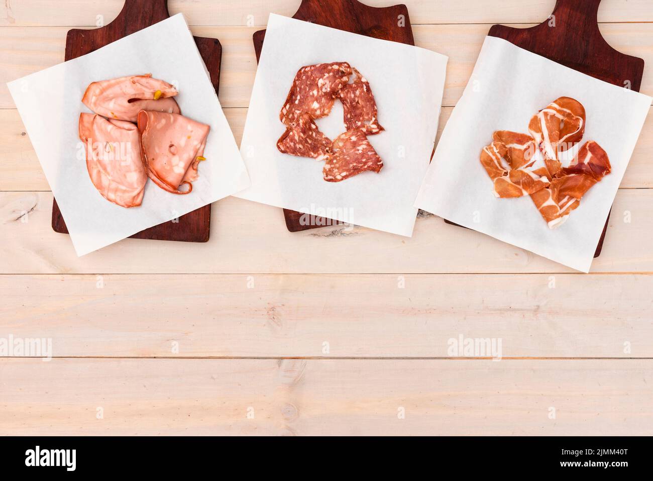 Different italian ham salami cutting board table Stock Photo - Alamy