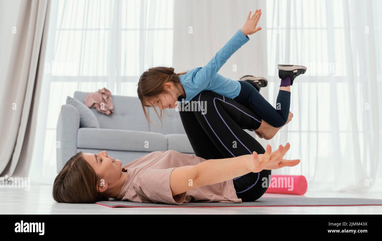 Mother training with child home Stock Photo - Alamy