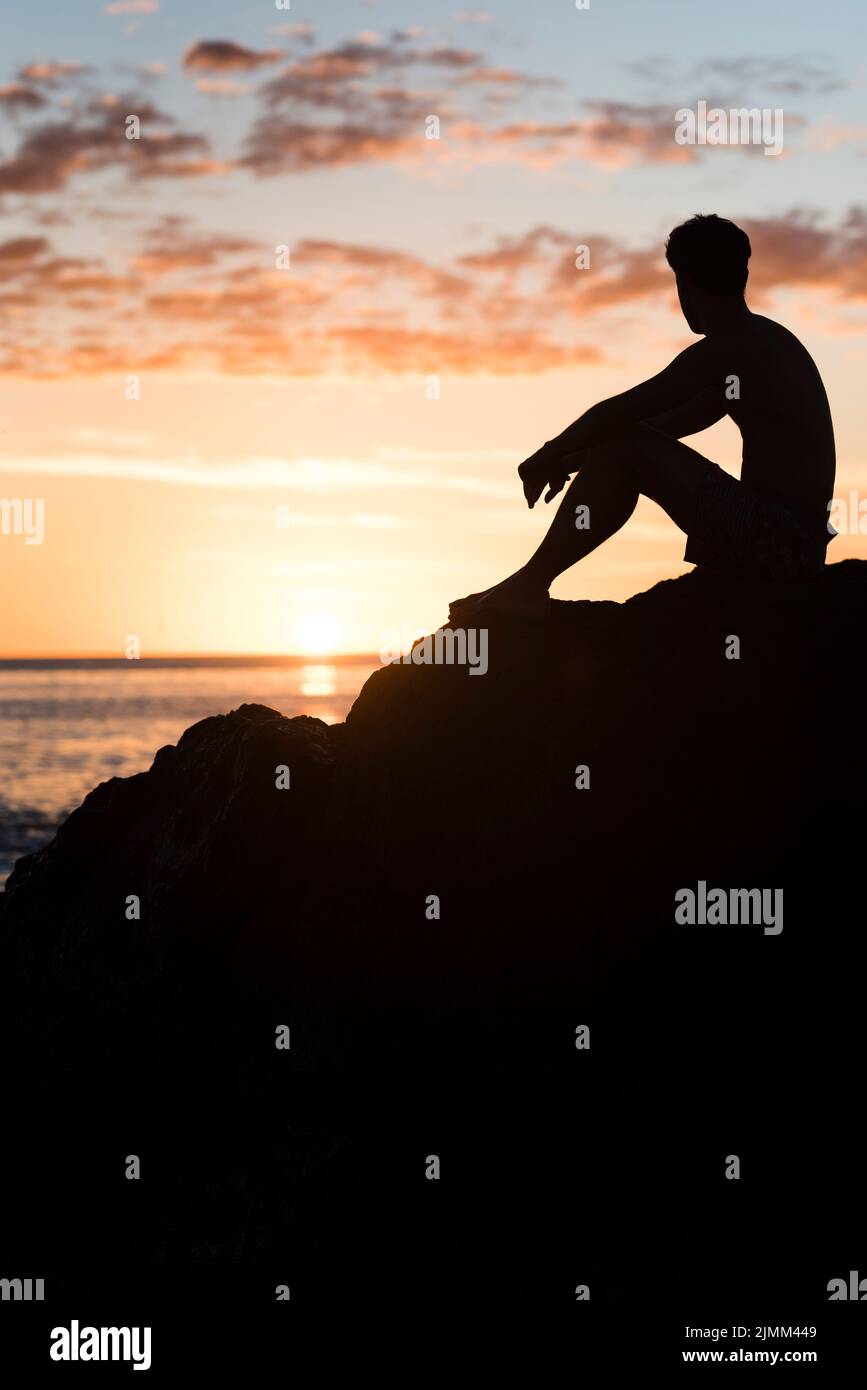 Man relaxing beach sunset Stock Photo - Alamy