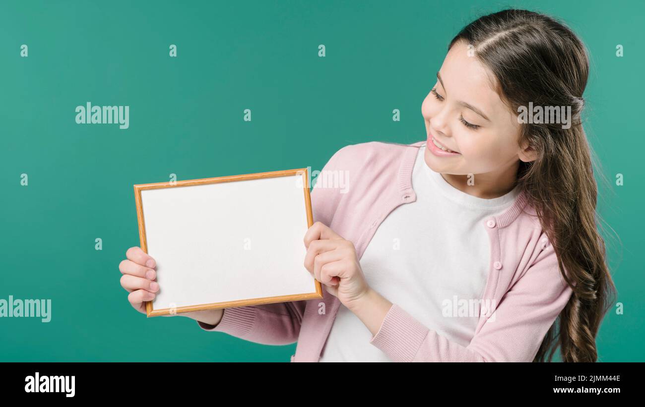 Girl holding empty picture frame Stock Photo - Alamy