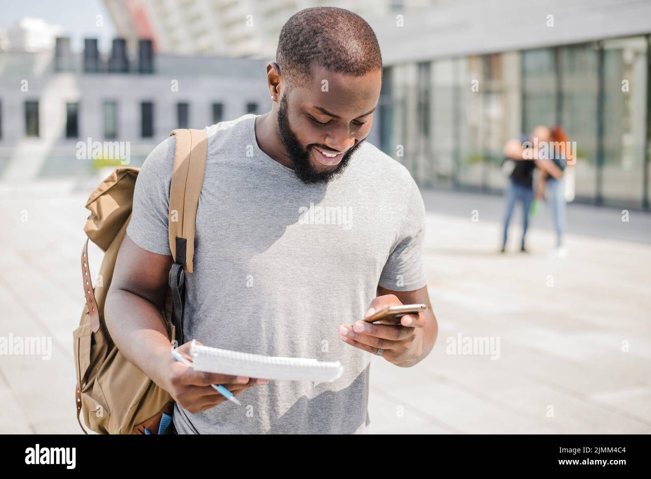 Joyful young university student using hi-res stock photography and ...