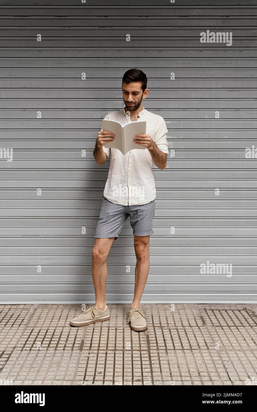 Man reading interesting book Stock Photo - Alamy
