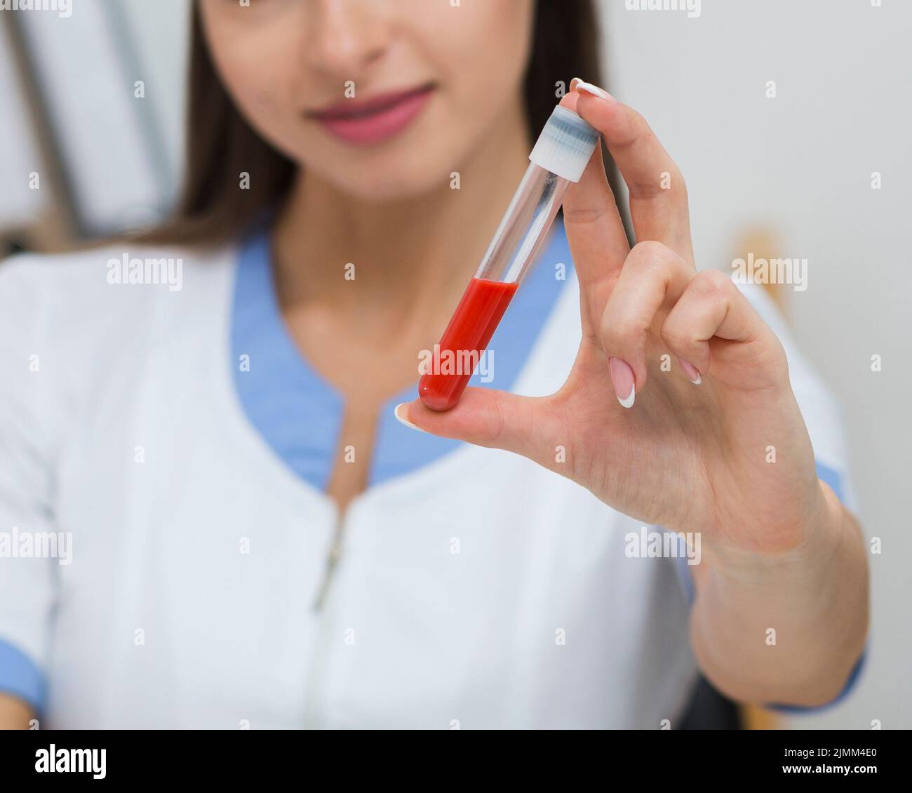 Woman hand holding blood sample Stock Photo - Alamy