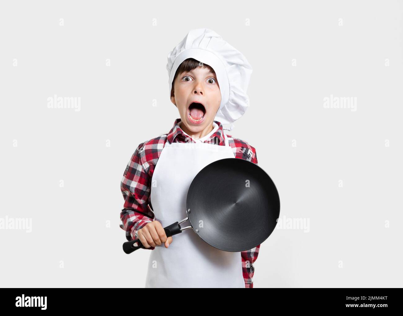 Young child with pan surprised Stock Photo - Alamy