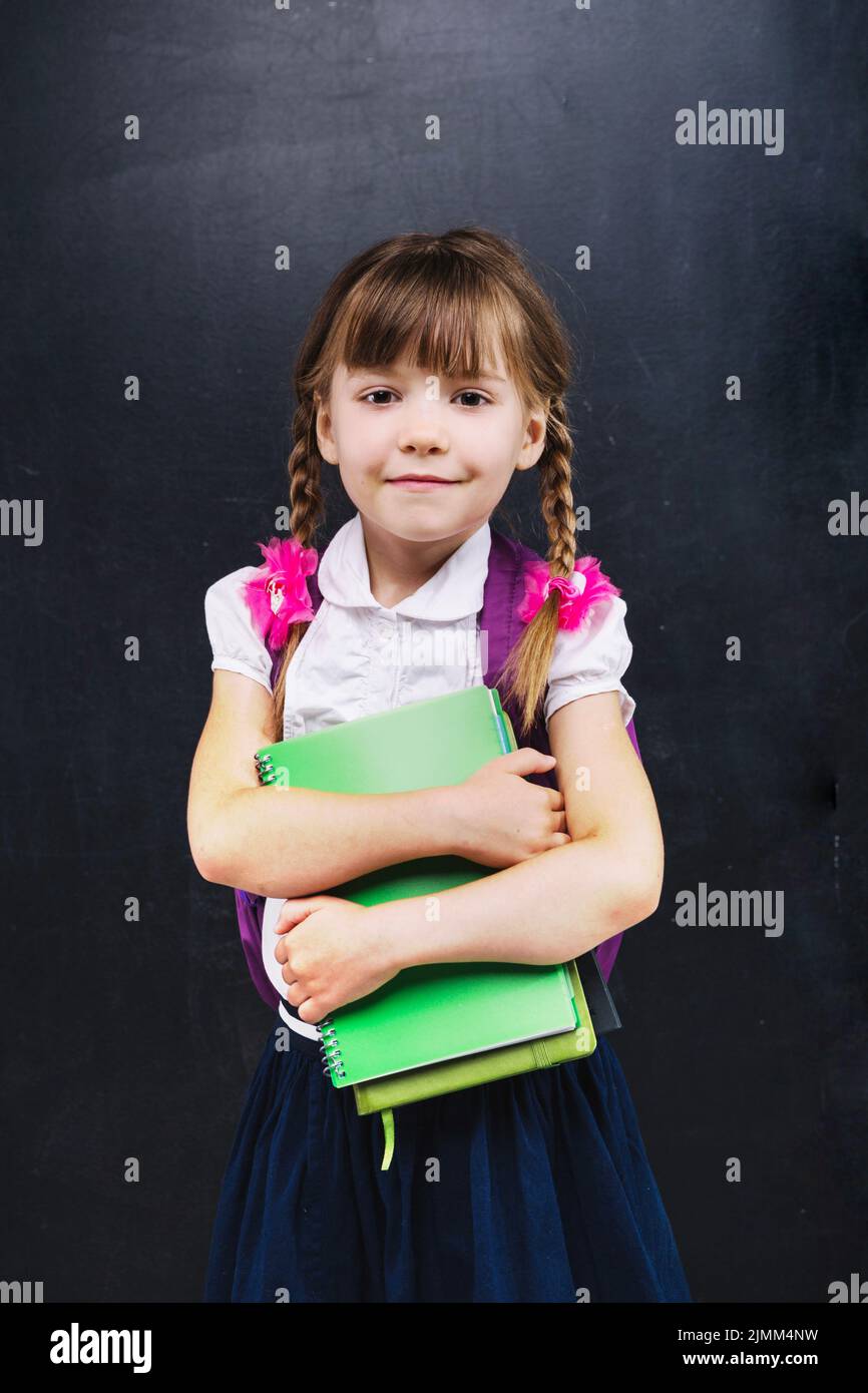 Little schoolgirl with books Stock Photo - Alamy