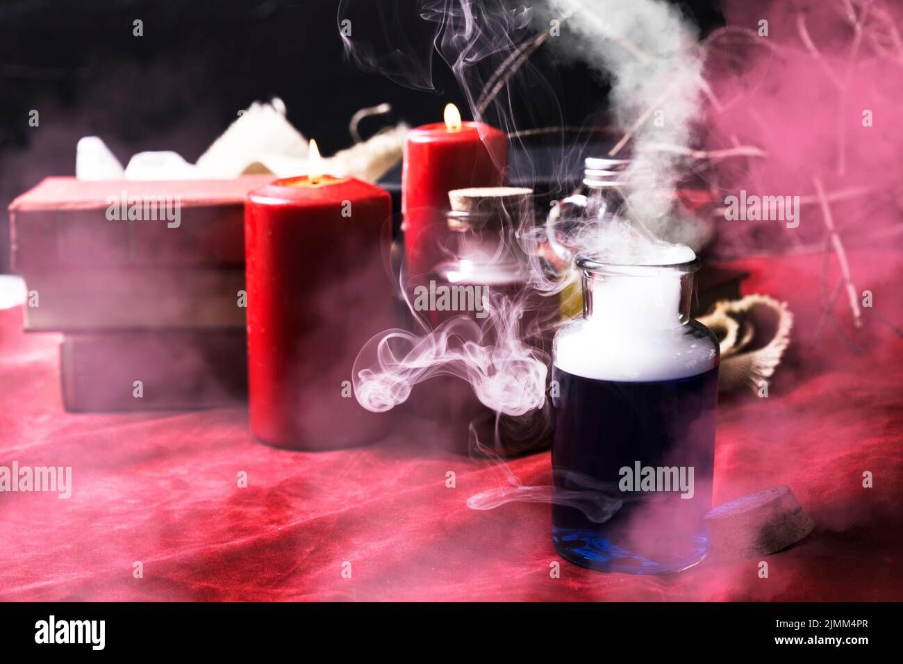 Smoky blue potion with halloween decorations Stock Photo - Alamy