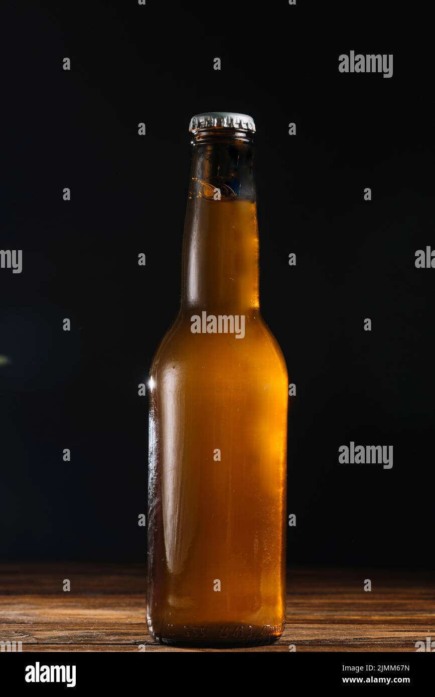 Close up beer bottle wooden desk Stock Photo - Alamy