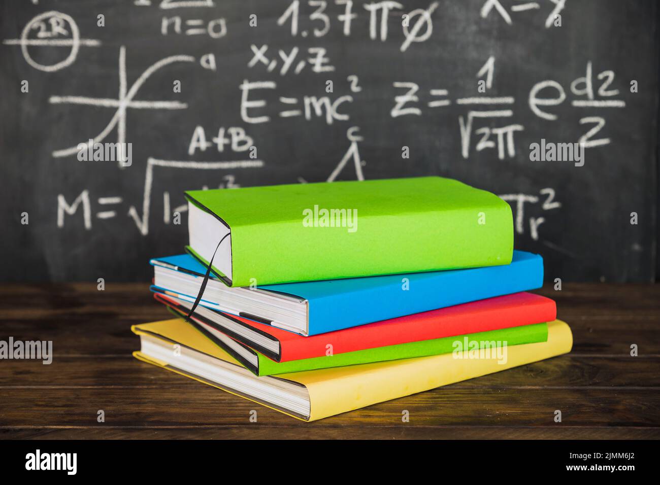 Books desktop near chalkboard Stock Photo - Alamy