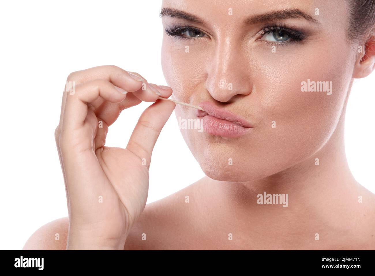 Serious woman with toothpick on white background Stock Photo - Alamy