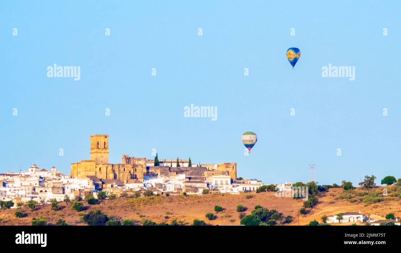 A large hot air balloon flying over Arcos de la Frontera during the ...