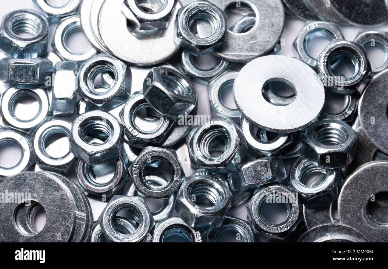 Metal nuts and washers for bolts isolated on white. Nuts for bolts ...
