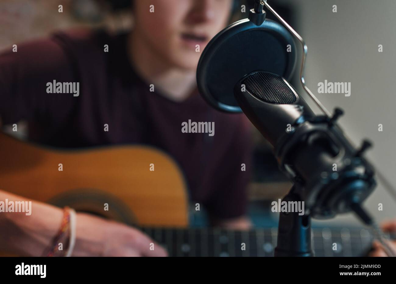 Microphone with pop filter closeup photo with a young teenager boy in ...