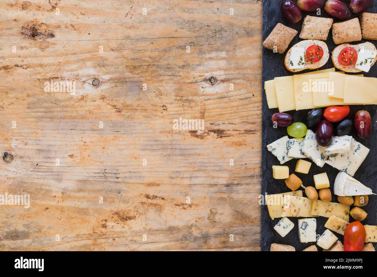 Cheese platters black slate board table Stock Photo - Alamy