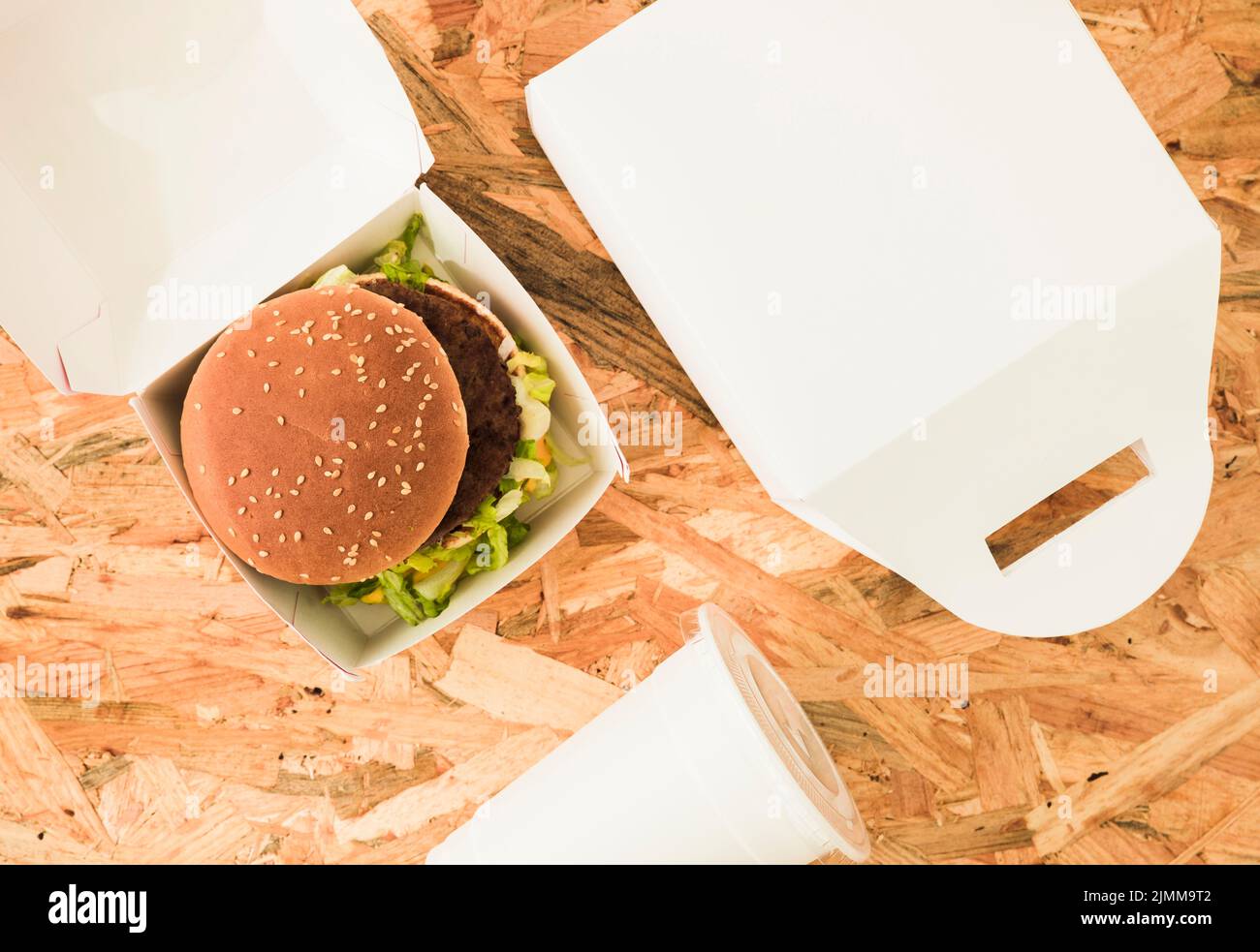 Overhead view burger package wooden background Stock Photo - Alamy