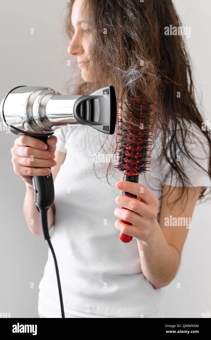 Young female drying hair Stock Photo - Alamy