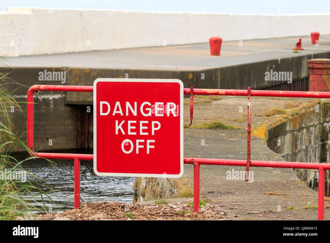 Red and White Danger Keep Off sign fitted to a metal fence Stock Photo ...