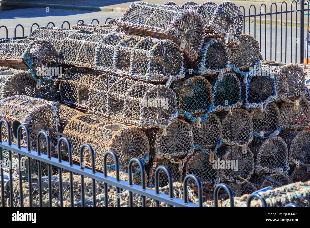 Stack of Lobster pots in a fenced compound on the harbour wall Stock ...