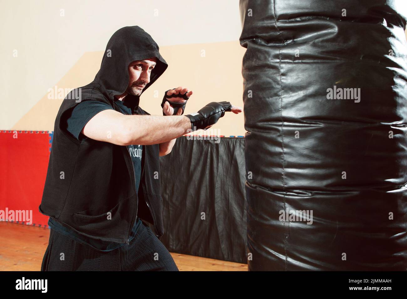 Kick boxing man with punching box Stock Photo - Alamy